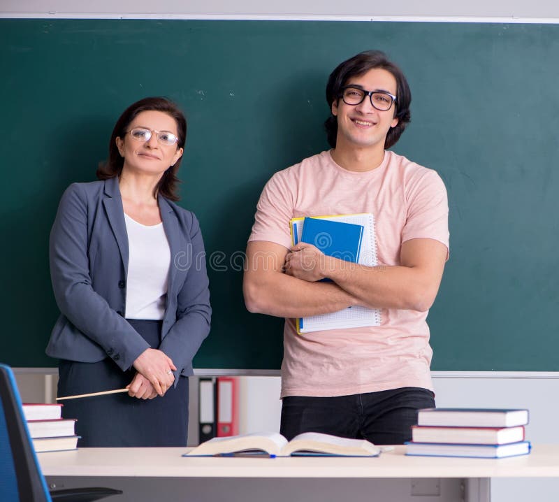 Old Female Teacher and Male Student in the Classroom Stock Photo ...