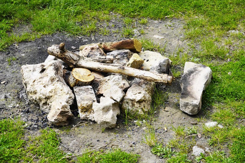 Old fire pit on the lawn. stock photo. Image of stone - 259816430