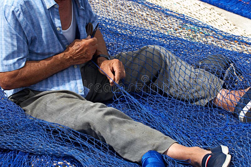 Old Fisherman Mending Nets stock image. Image of hand - 1785759