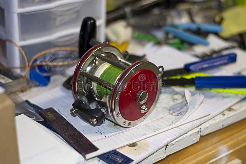 Old Fishing Reel on Bench with Tools in Background Stock Photo - Image ...