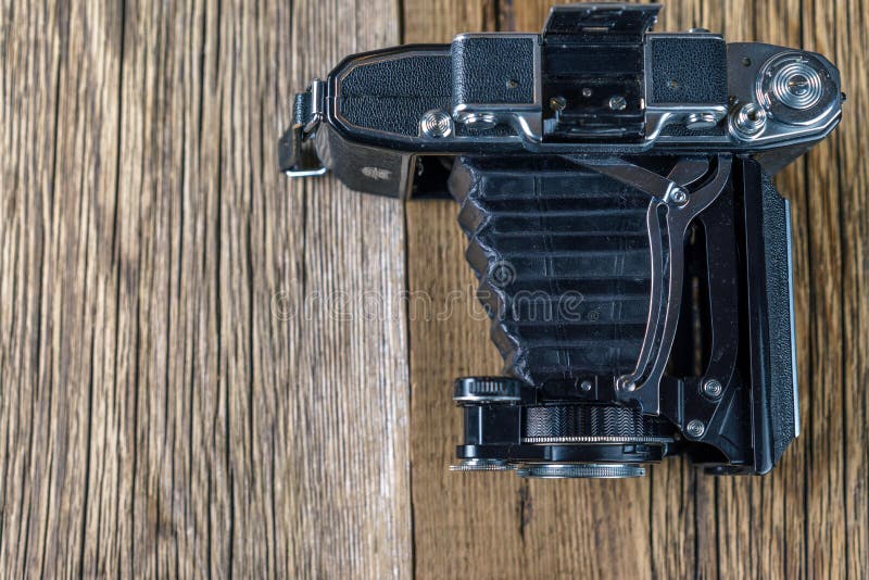 Old Folding Camera on a Textured Rustic Wooden Surface. Stock Photo ...