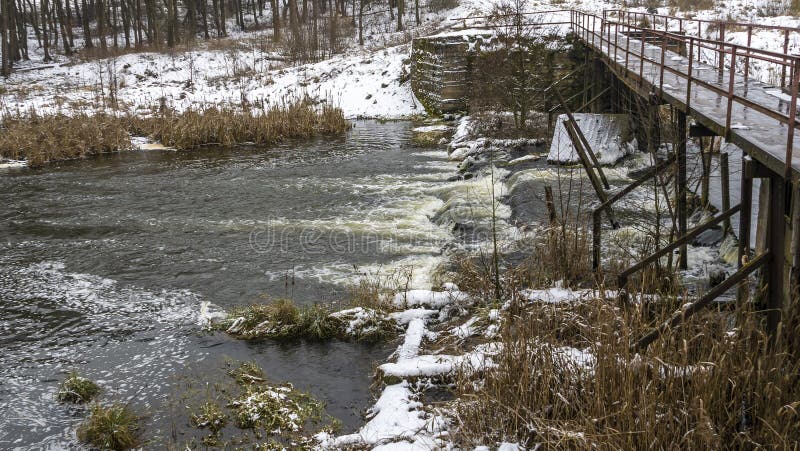 An Old Footbridge Over a Small River. First Snow in the Countryside ...