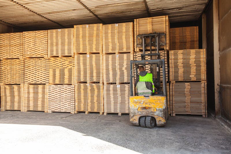 The Old Forklift Load Lumber into Dry Warehouse Stock Photo - Image of ...