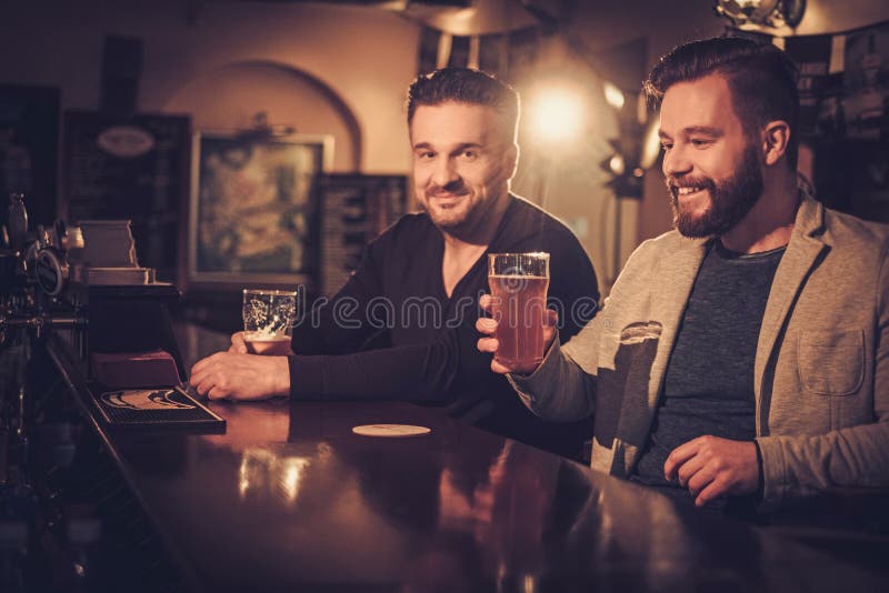 Old Friends Drinking Draft Beer at Bar Counter in Pub. Stock Photo ...