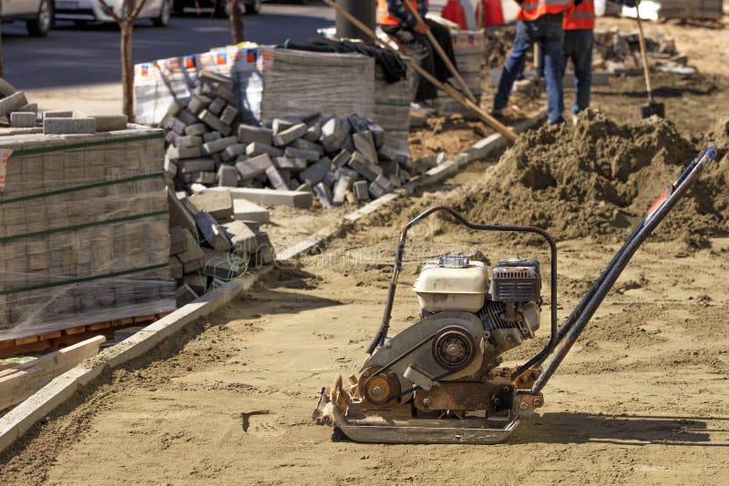 An Old Gasoline Compactor for Compacting Sandy Soil Stands Opposite a ...