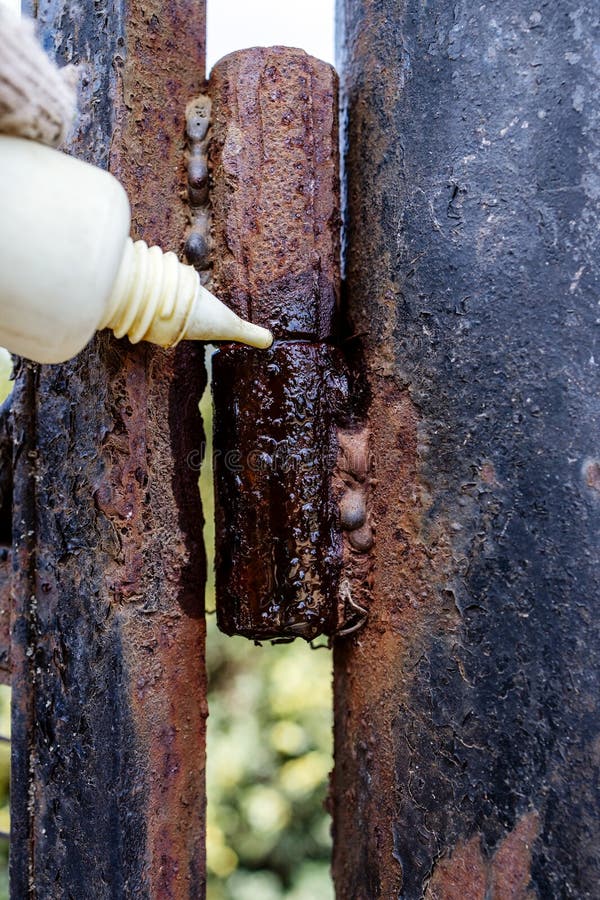 Old Gate Hinge is Lubricating with Oil from Oiler Stock Image - Image ...