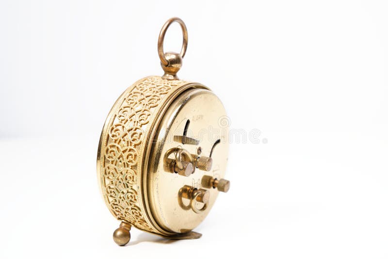 An Old Golden Analog Alarm Clock with Mechanical Movement Stock Photo ...