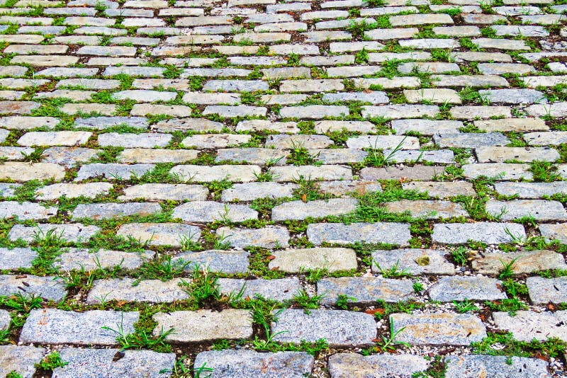 Old Granite Cobblestone Driveway Pavers. Weathered Texture with Grass ...