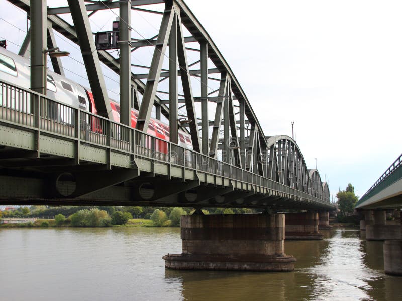 Old Green Metal Railroad Bridge with Red Train Crossing River Stock ...
