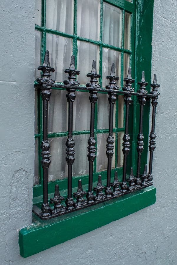 An Old Green Window with Black Railings Stock Photo - Image of house ...