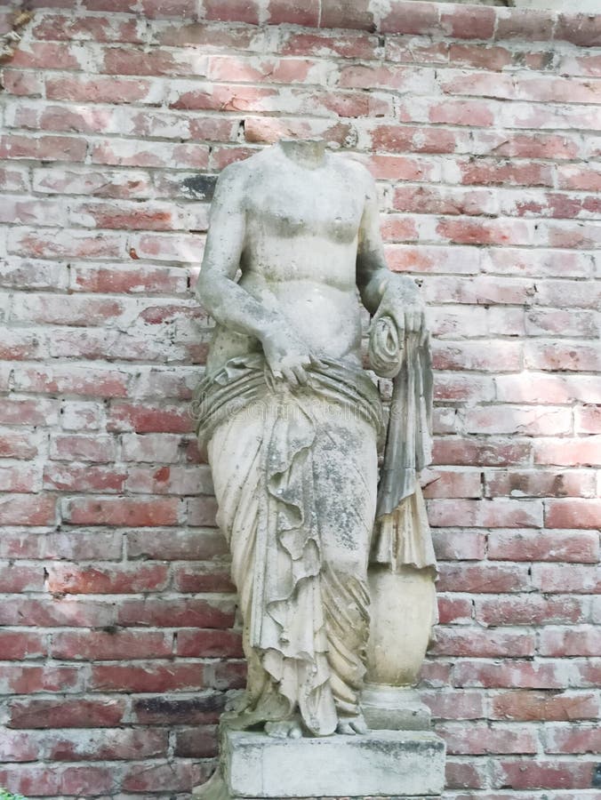 Old Grey Statue Near Old Bricks Wall Stock Photo - Image of iron ...