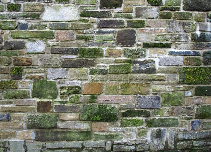 Old Grey Stone Wall Made of Large Irregular Blocks Covered in Patches ...