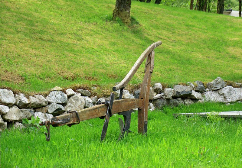 Old Hand Plough Lying in a Green Field Stock Photo - Image of green ...