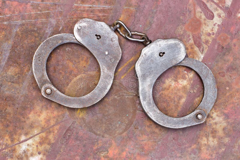 Old Handcuffs on the Table. Old Rusty Metal Stock Photo - Image of lock ...