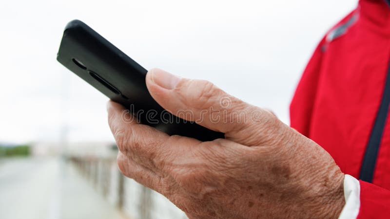 Old Hands on a Smartphone stock photo. Image of device - 332456234