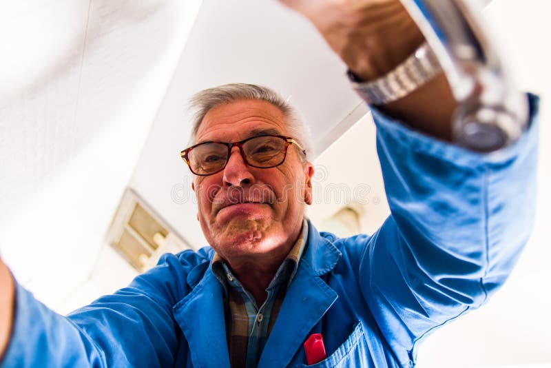 Old Handyman Working in the Kitchen Stock Photo - Image of angle ...