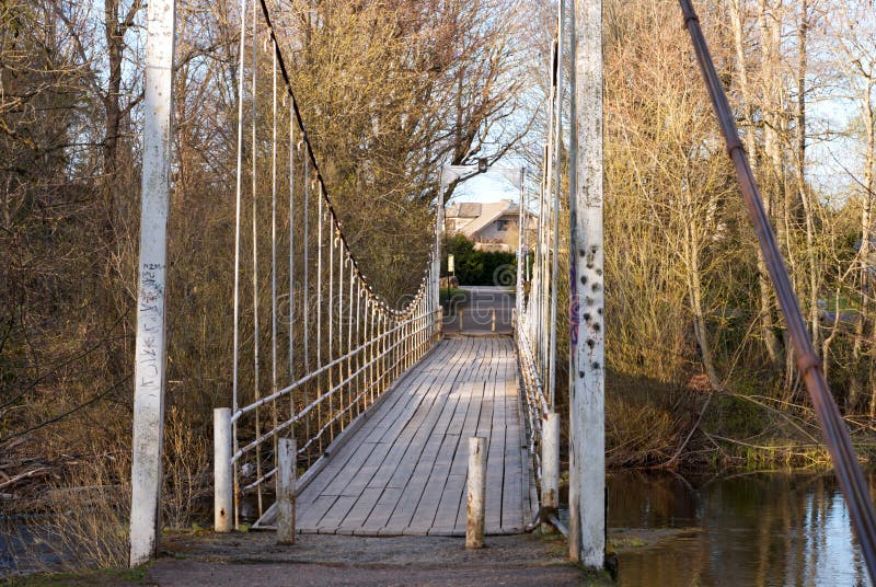 The Very Old Hanging Footbridge Across a Small River in Estonia Stock ...