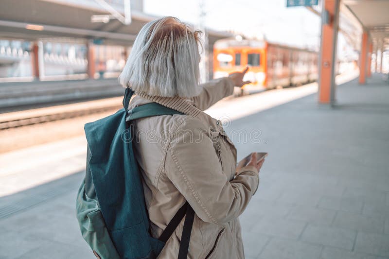 Old Happy Woman with Backpack Waiting Train on Station Platform with ...