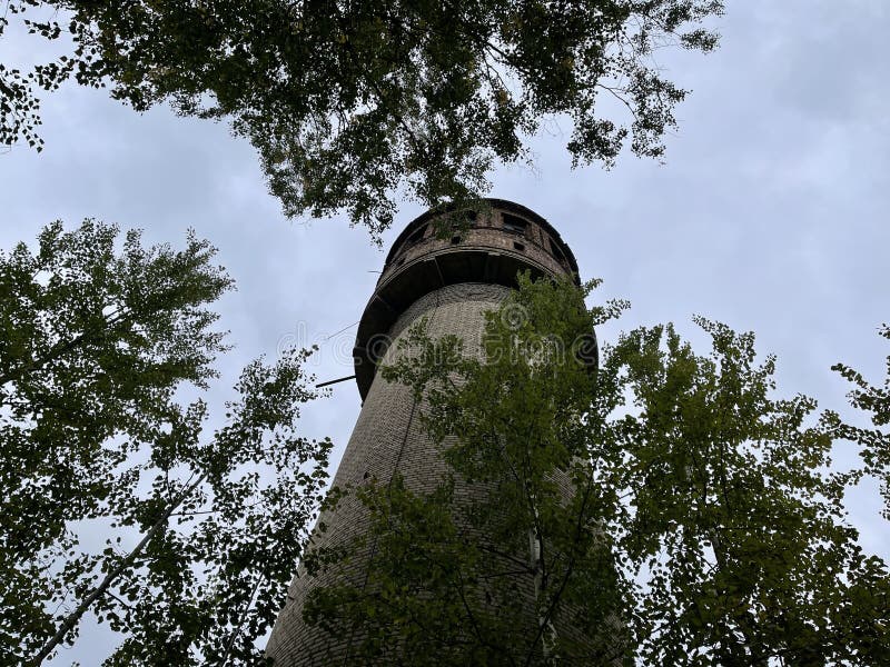 Old High Water Tower Surrounded by Trees. Brick Tower in Countryside ...