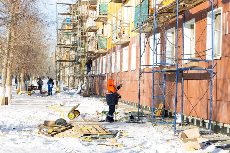 Workers Warm and Repair the Facade of the Building. Stock Photo - Image ...