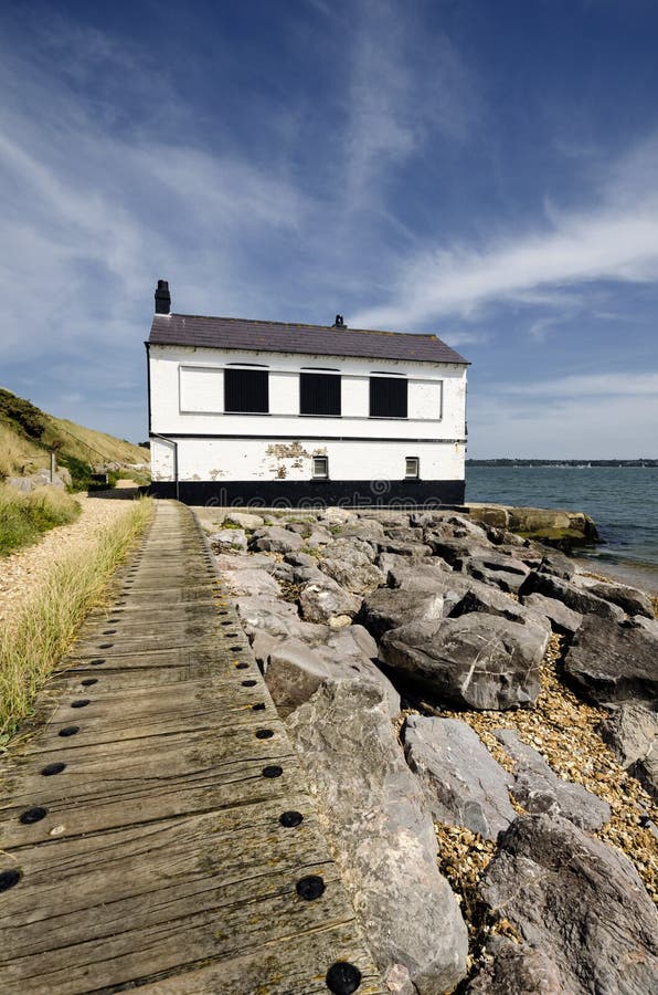 Old house on shore at Lepe stock image. Image of rock - 28226427