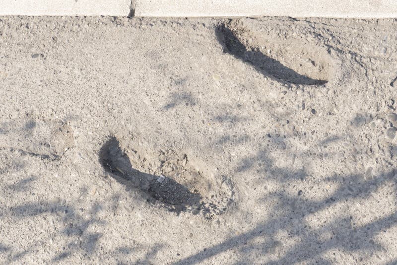 Old Human Footprints in the Concrete Floor. Boot Marks Left by a Man in ...