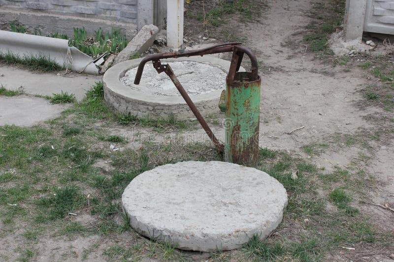 Old Hydrant and Two Concrete Hatch Covers Stock Photo - Image of soil ...