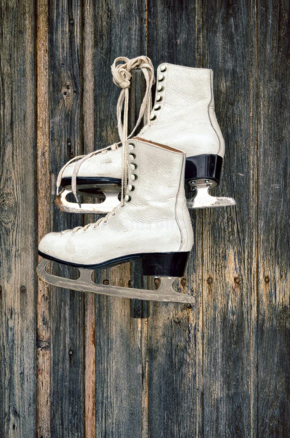 Old Figure Ice Skates on a Rustic Wooden Wall Stock Photo - Image of ...