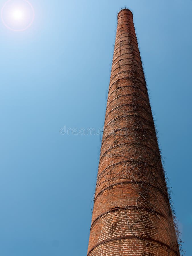Old Industrial Chimney Against Sky, Lens Flare Stock Photo - Image of ...