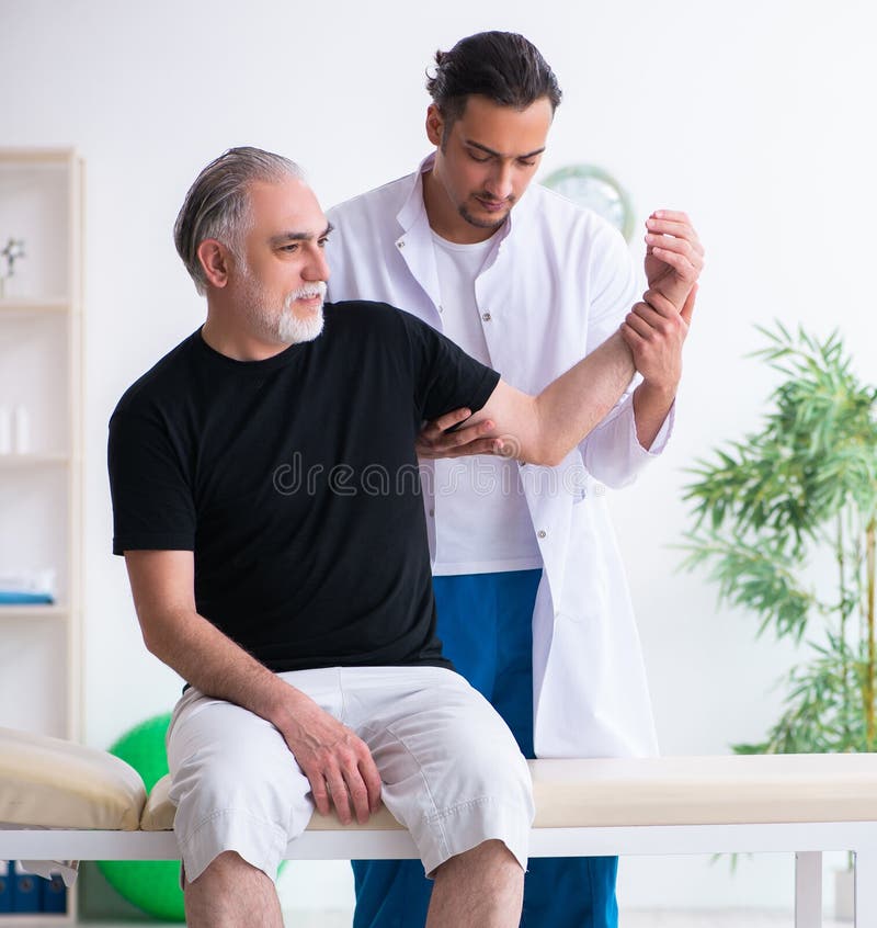 Old Injured Man Visiting Young Doctor Stock Photo - Image of orthopedic ...