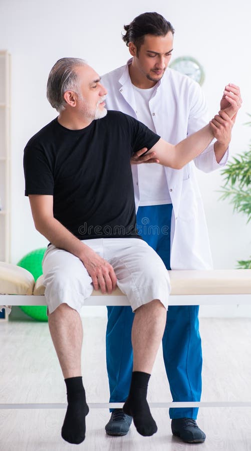 Old Injured Man Visiting Young Doctor Stock Photo - Image of injury ...