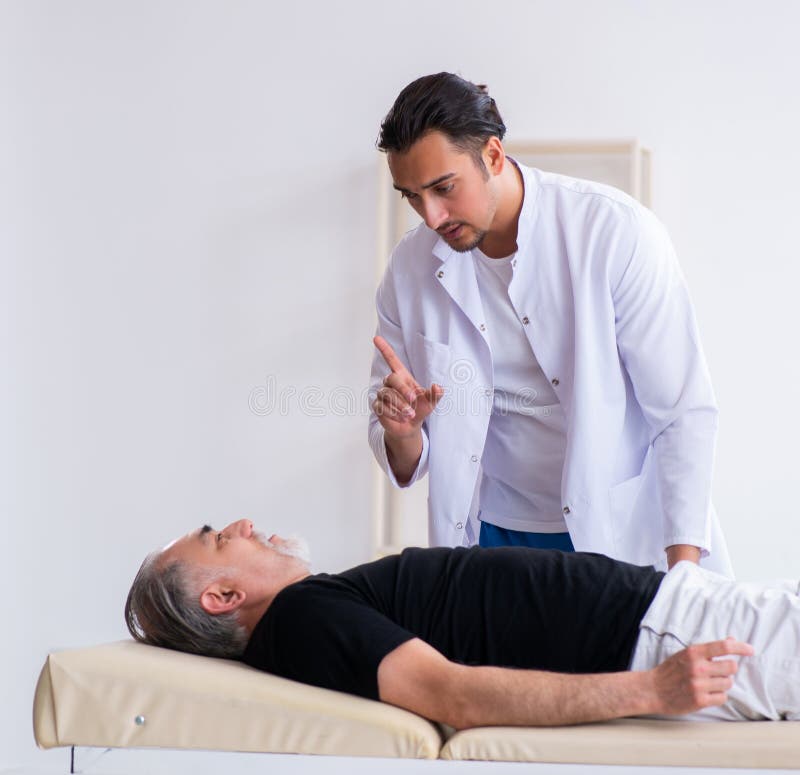 Old Injured Man Visiting Young Doctor Stock Photo - Image of doctor ...