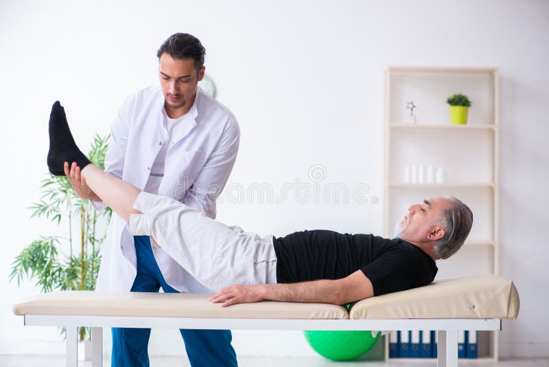 Old Injured Man Visiting Young Doctor Stock Photo - Image of explaining ...