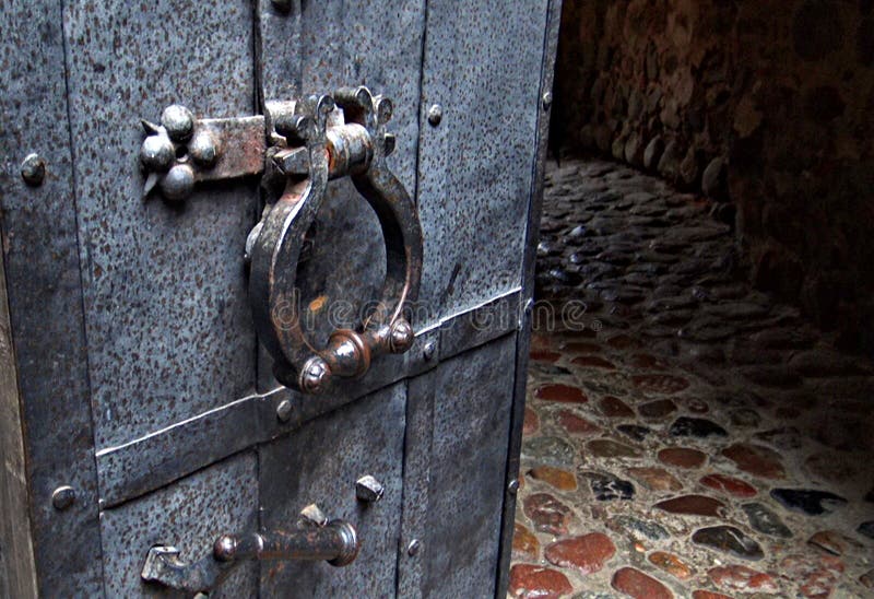 An Old Iron-bound Door with Large Ring Opens Passage through an Earthen ...