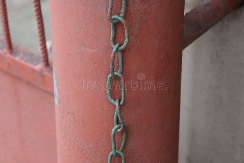 Old Iron Chain Hanging on a Red Metal Pipe Stock Photo - Image of gray ...