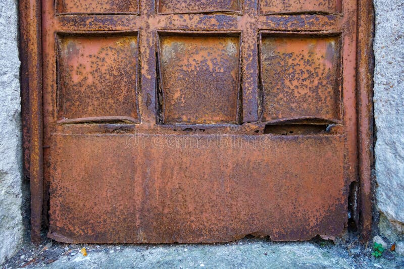 An Old Iron Door with Bars, Rusty, and a White Stone Wall Stock Photo ...