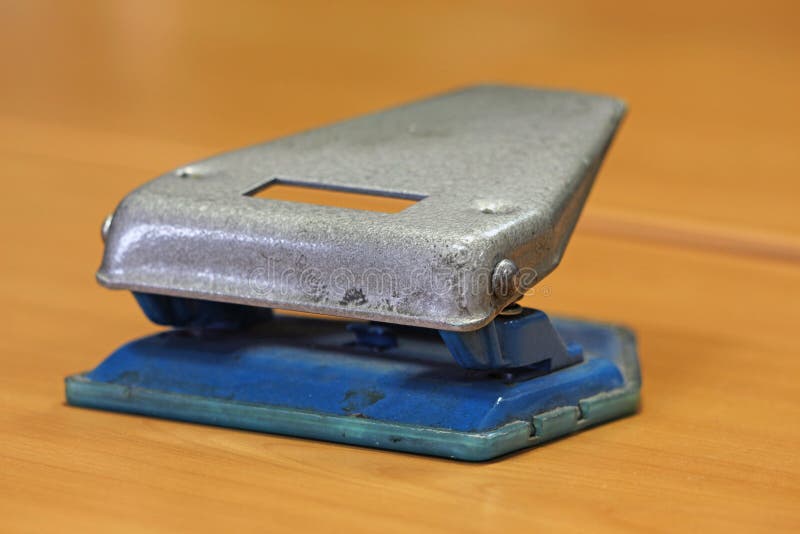 Old Iron Puncher on a Yellow Table Stock Photo - Image of office ...