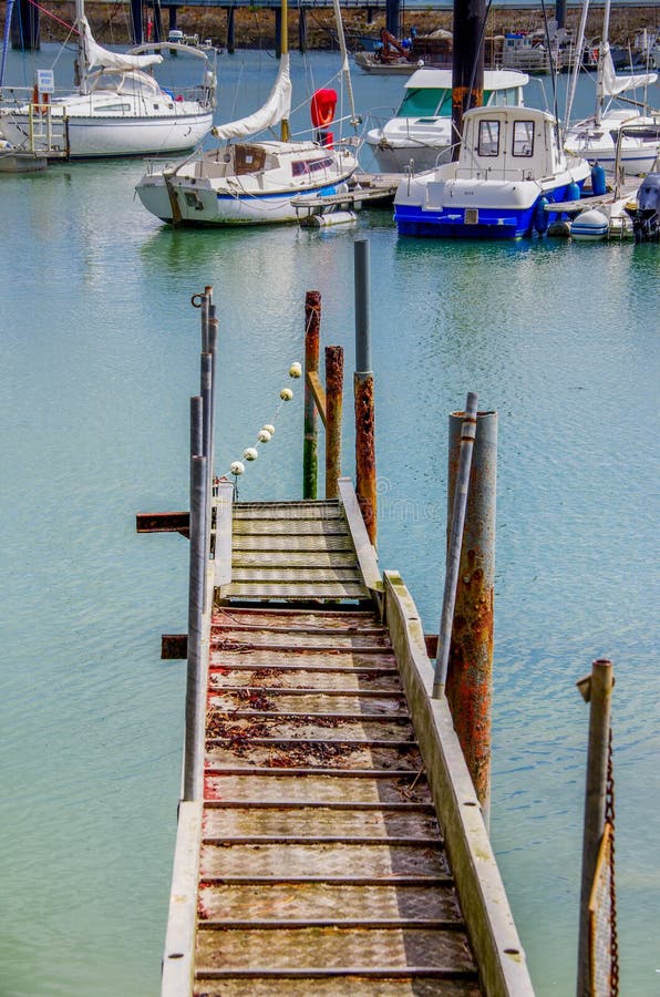 Old Jetty with Boats in the Background Editorial Image - Image of ...