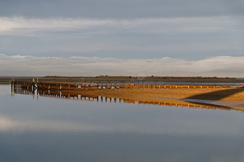 A Reflection of an Old Jetty in Early Evening Light Stock Image - Image ...