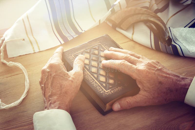 Jewish Man Hands Holding a Prayer Book, Praying, Next To Tallit. Jewish ... Jewish Man Hands Holding a Prayer Book, Praying, Next To Tallit. Jewish ...