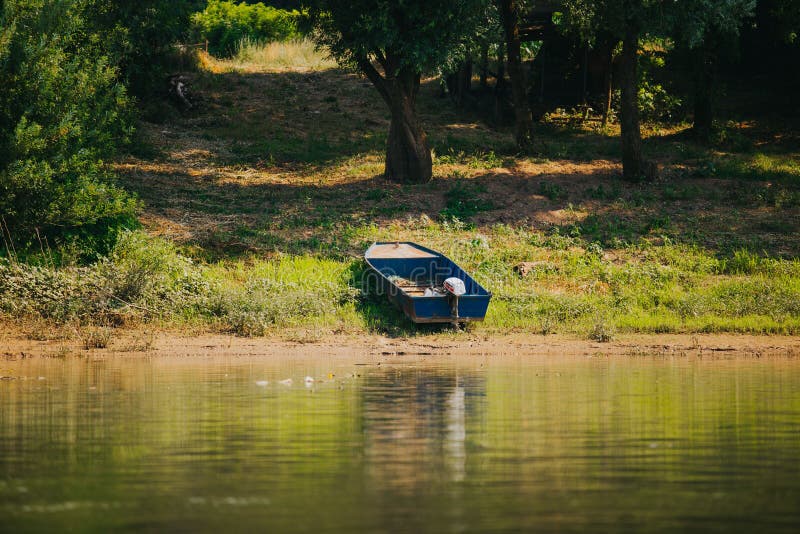 Old Kayak Parked on a Coast with Green Trees Stock Image - Image of ...