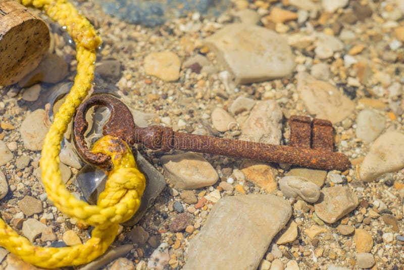 Old key in the sea stock photo. Image of pebble, washed - 32620624