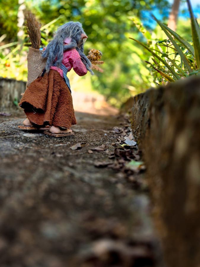 Old Lady Elf Walking among the Garden on the Cement Path. Stock Image ...