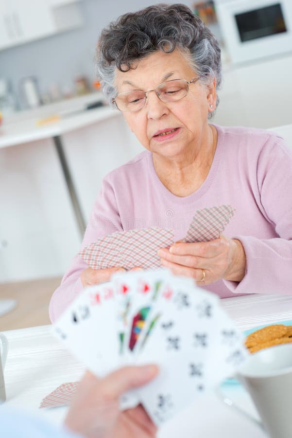 Old lady playing card game stock image. Image of concentrated - 102047023