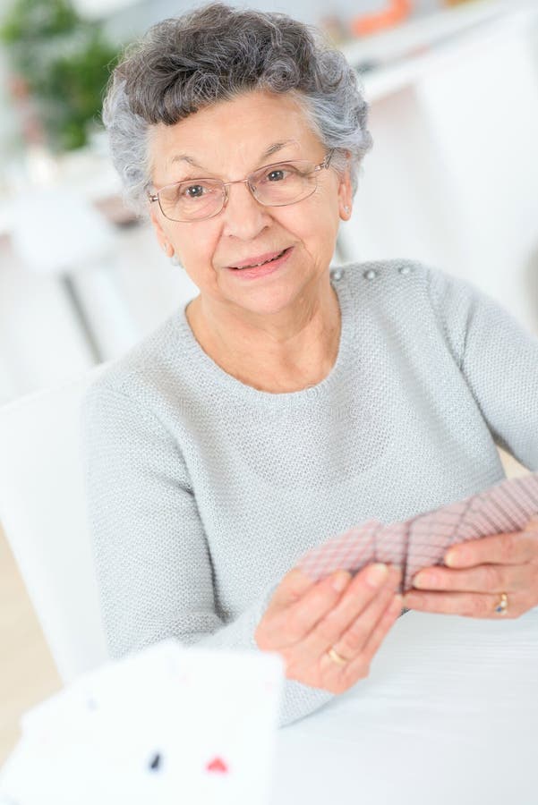 Old lady playing cards stock photo. Image of people - 261512128
