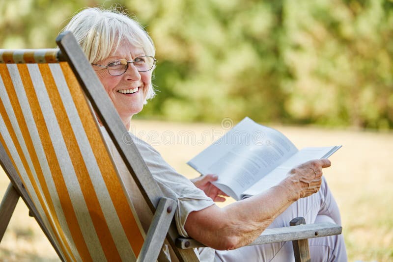 Old Lady Reading a Book and Smiling Stock Image - Image of information ...