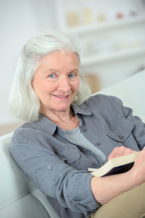 Old lady reading on sofa stock photo. Image of sofa, studying - 88457884