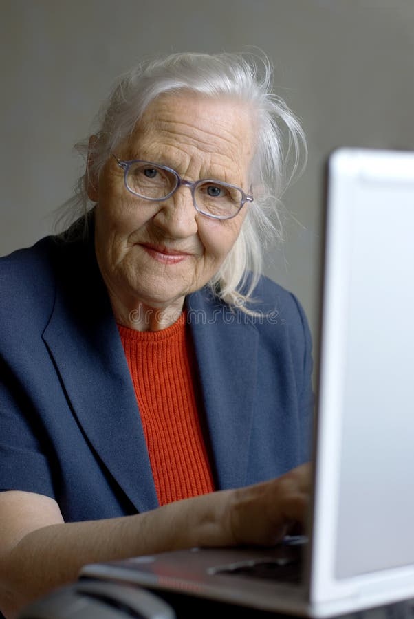 Old lady typing on laptop stock image. Image of white - 9508907