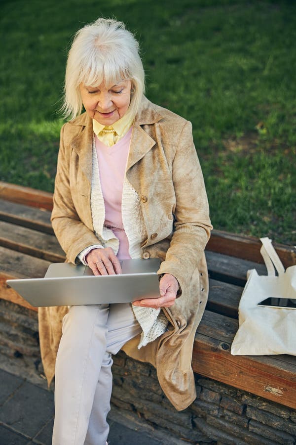 Old Lady Using Computer and Resting in Park Stock Photo - Image of ...