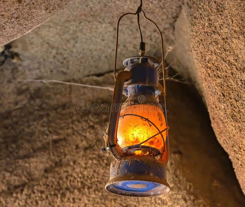 An Old Lantern Hangs from a Rock Above a Fire Pit Stock Photo - Image ...